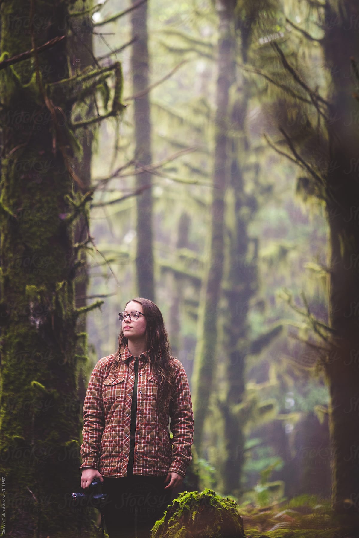 "A Young Woman Stands Looking Into The Distance In A Forest Wrapped In ...