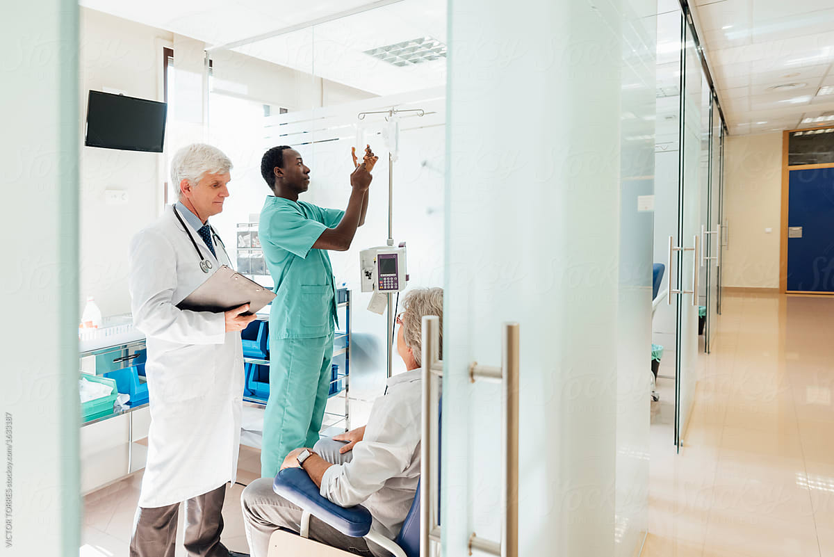 "Medics And Patient In Office" by Stocksy Contributor "VICTOR TORRES ...