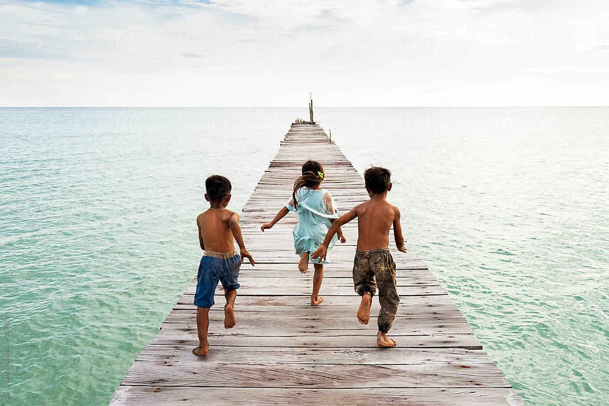 "Asian Kids Running On Pier Of Beach" by Stocksy Contributor "Santi ...