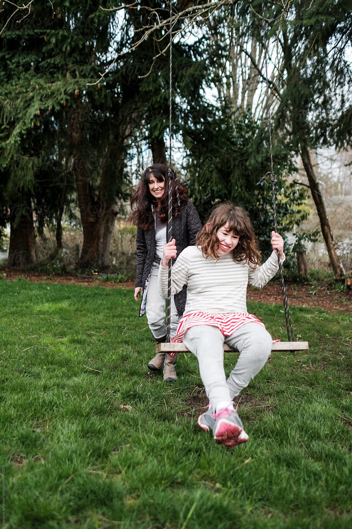 "Autistic Child Playing Swing With Her Mother" by Stocksy Contributor ...