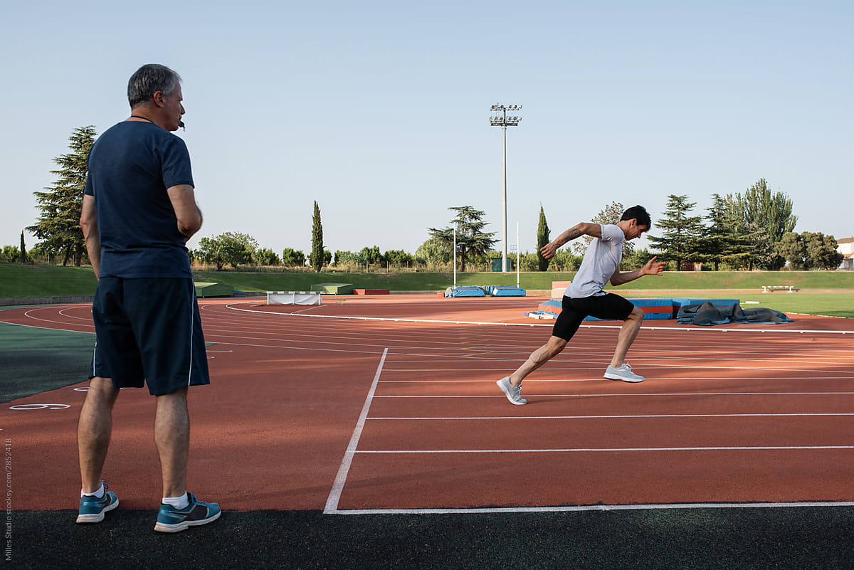 "Trainer Supervising Running Athlete On Track" by Stocksy Contributor ...