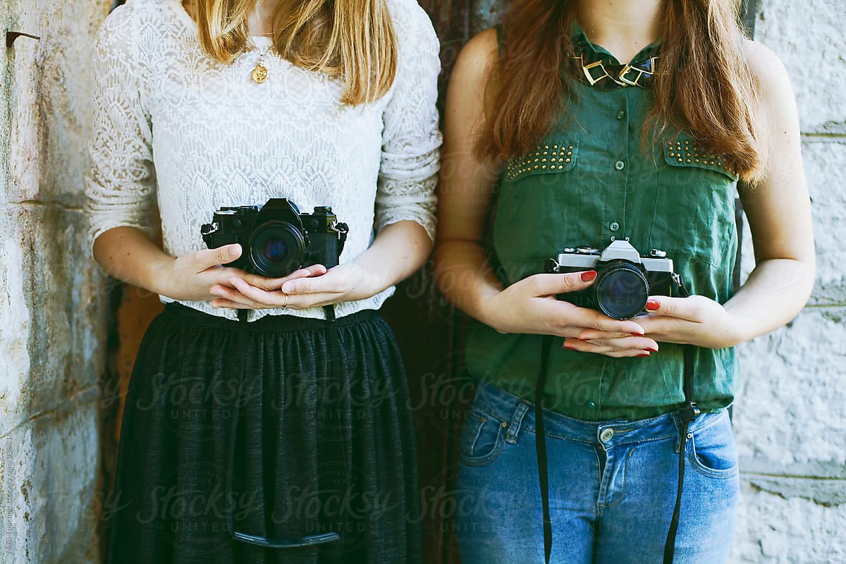 "Two Young Woman Photographers Holding Film Cameras In Hands" by ...