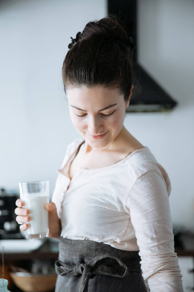 "Woman Holding Glass Of Milk Looking Down" by Stocksy Contributor ...