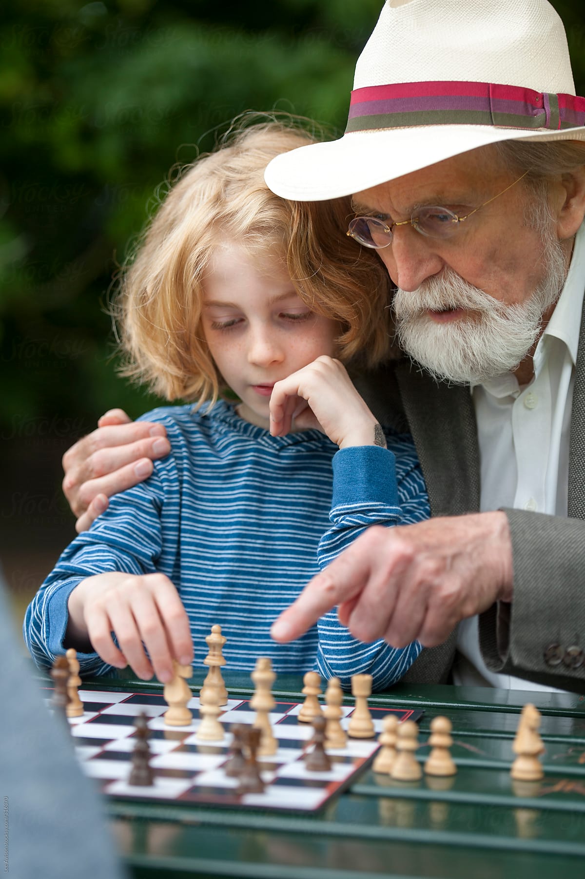 "Grandfather Playing Chess With His Grandchildren" by Stocksy ...