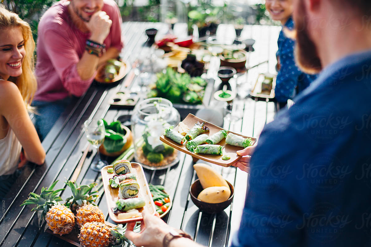 "Host Brings Food To Guests At Lunch" by Stocksy Contributor "Lumina ...