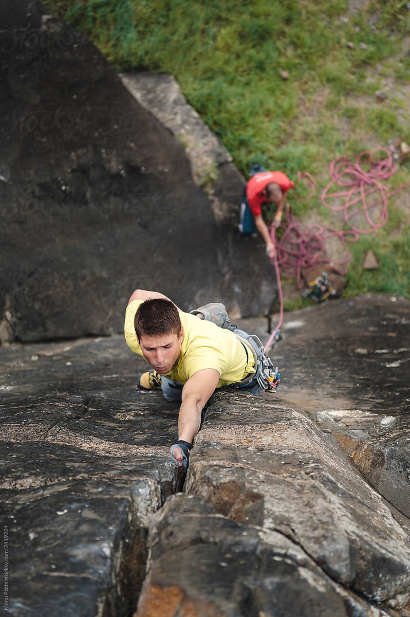 Climber climbing, sportsman workout, yellow t-shirt - Stock Image ...