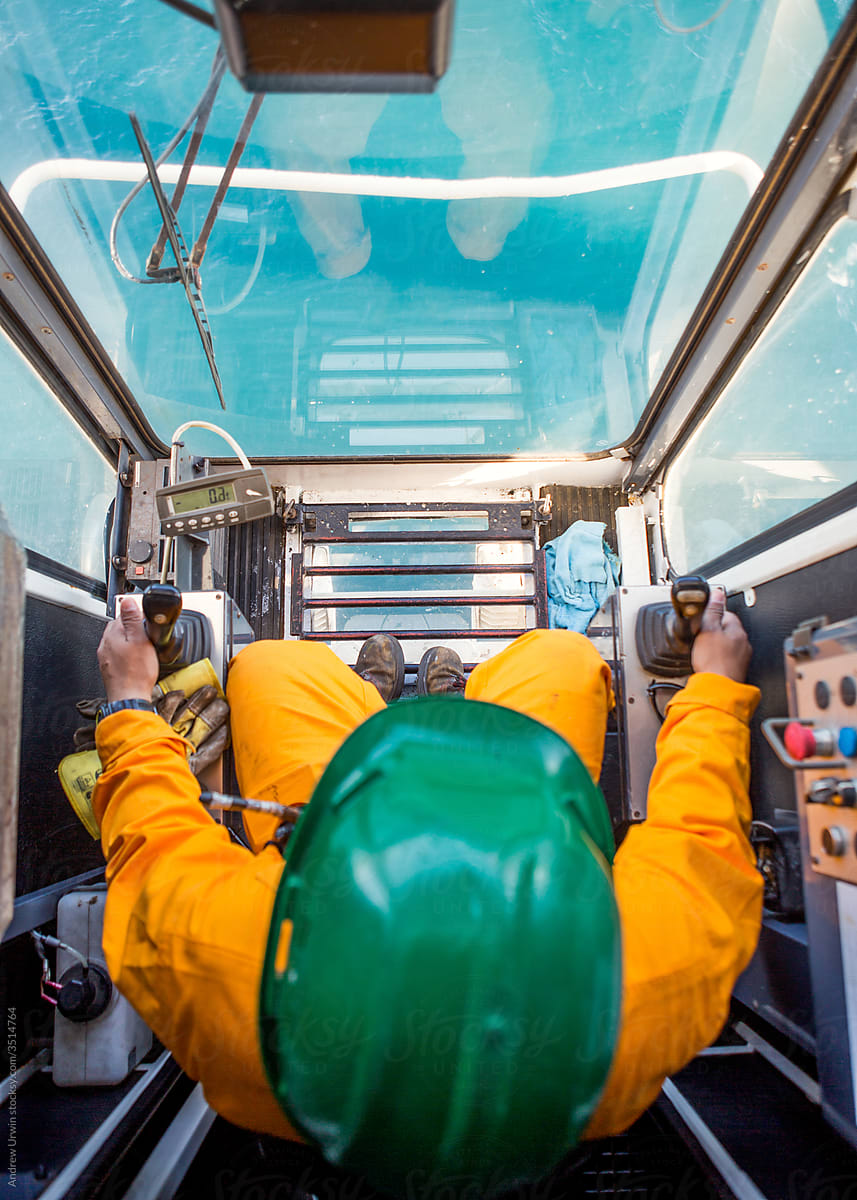 "A Worker In A Crane Cockpit" by Stocksy Contributor "Andrew Thomas ...