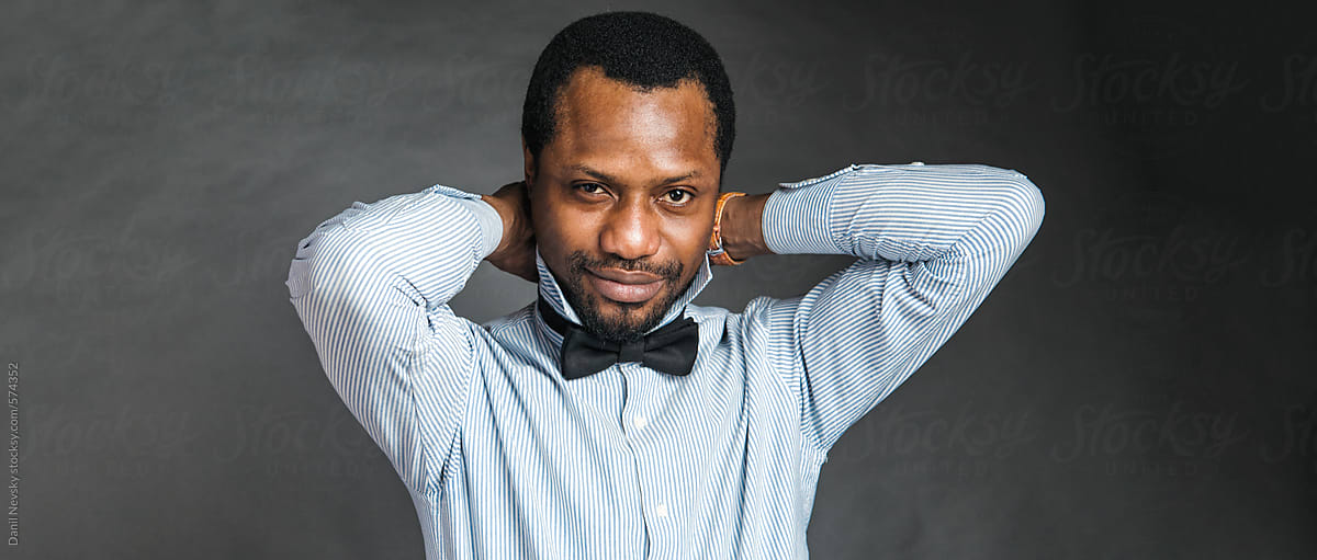 "Trendy Black Man Putting On Bow Tie" by Stocksy Contributor "Danil ...