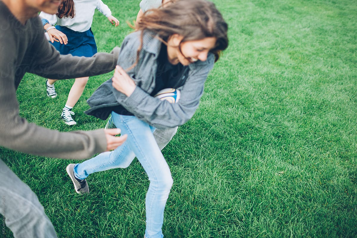 "Teenagers Friends Playing Rugby In The Park" by Stocksy Contributor ...