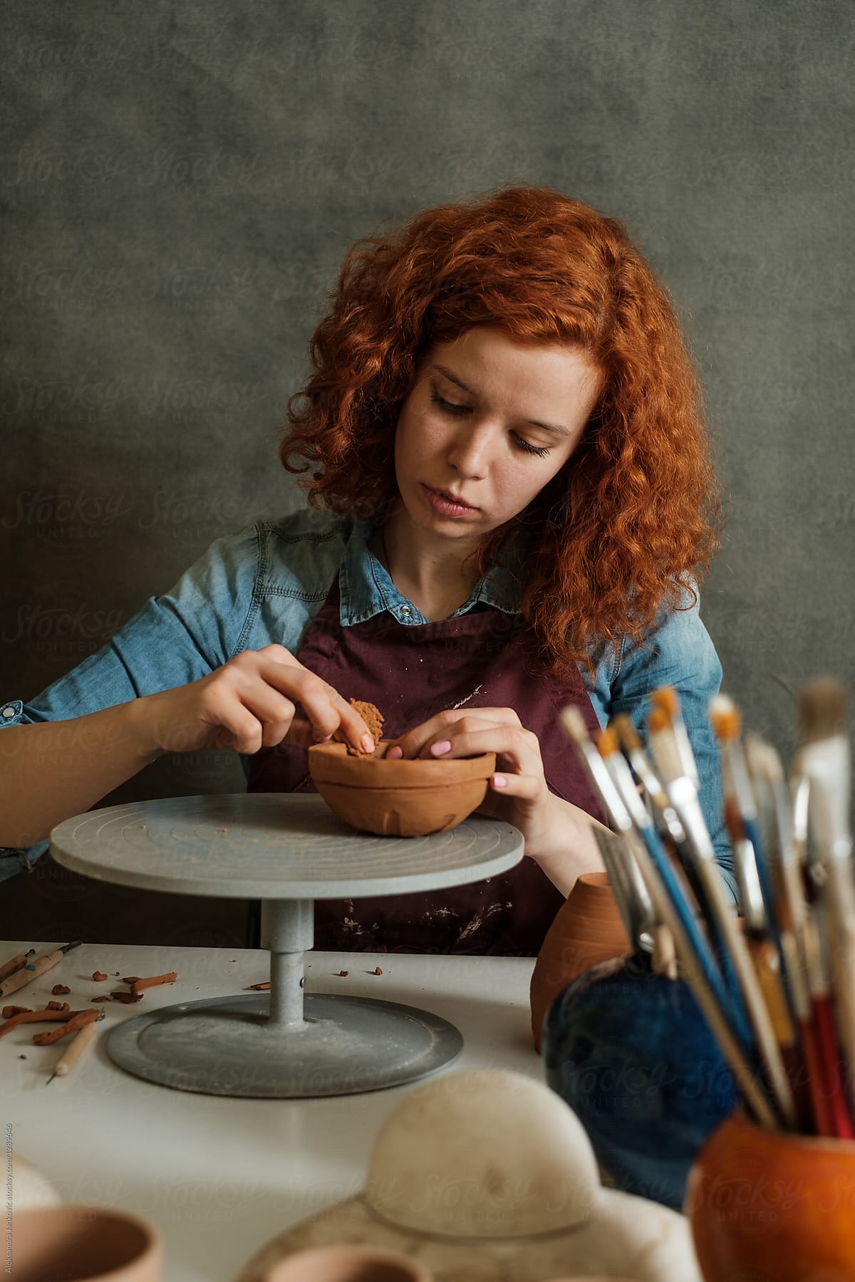 "Female Artisan Working On Clay Bowl At The Pottery Workshop" by ...