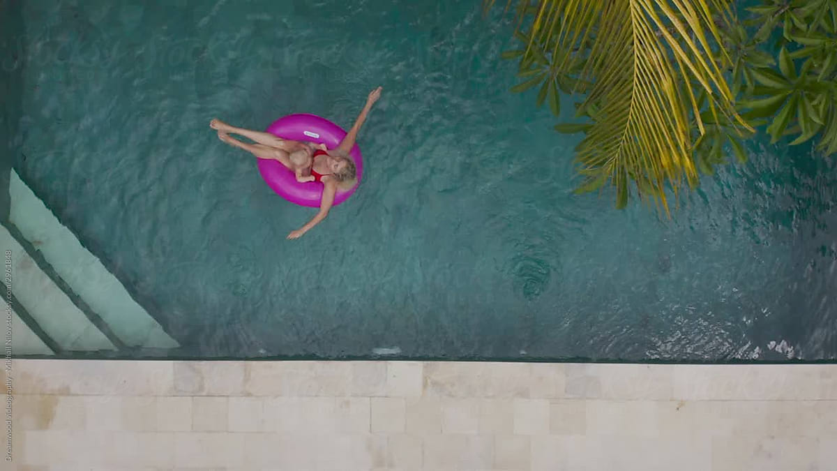 "Woman Relaxing In Backyard Pool" by Stocksy Contributor "Dreamwood ...
