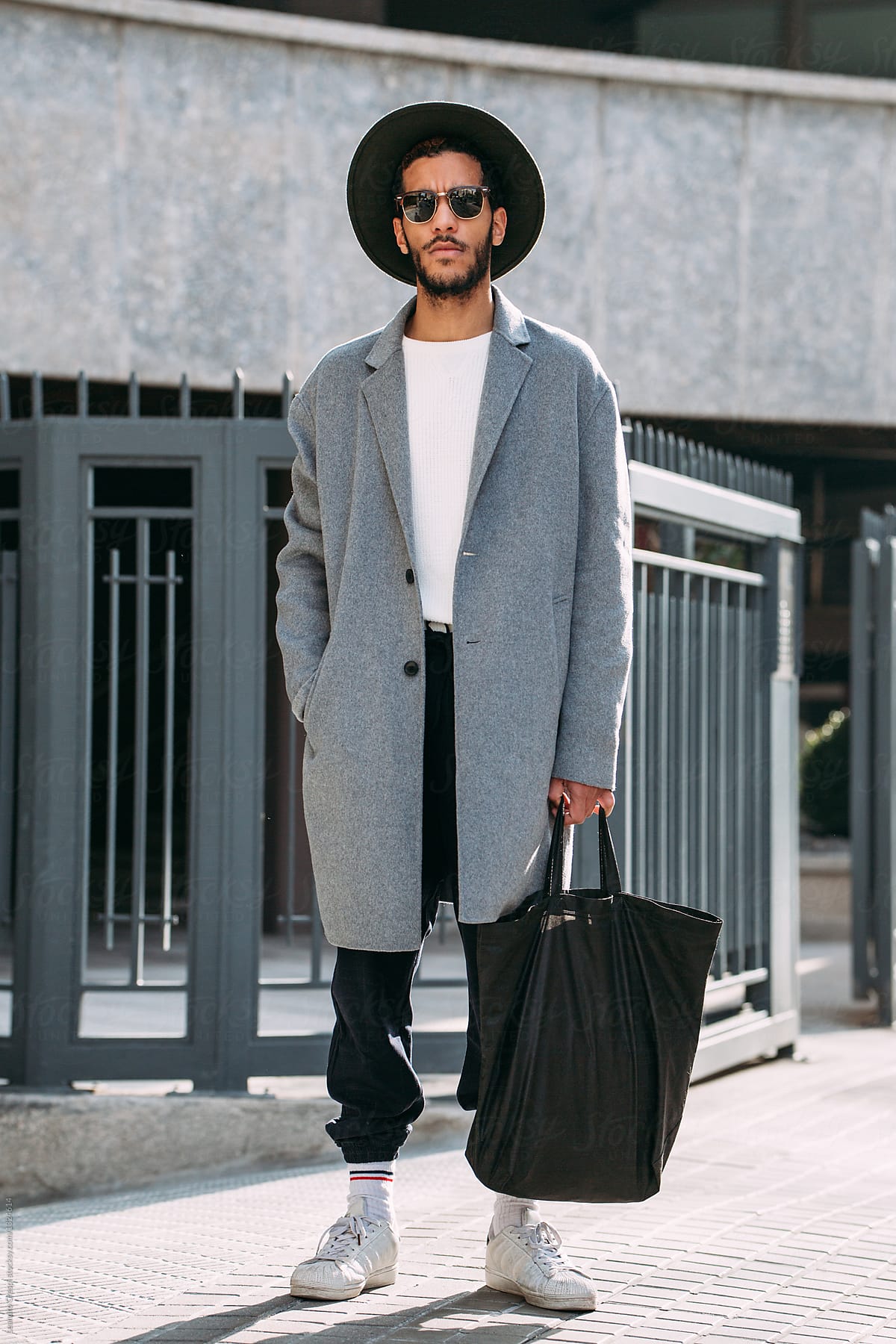 "Stylish Man With Handbag" by Stocksy Contributor "Leandro Crespi ...