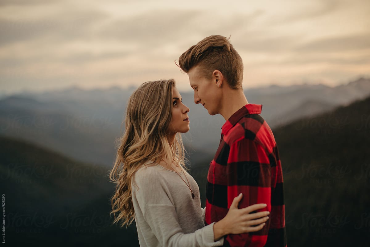 "Young Engaged Couple Explore Mountain Side At Sunset" by Stocksy ...