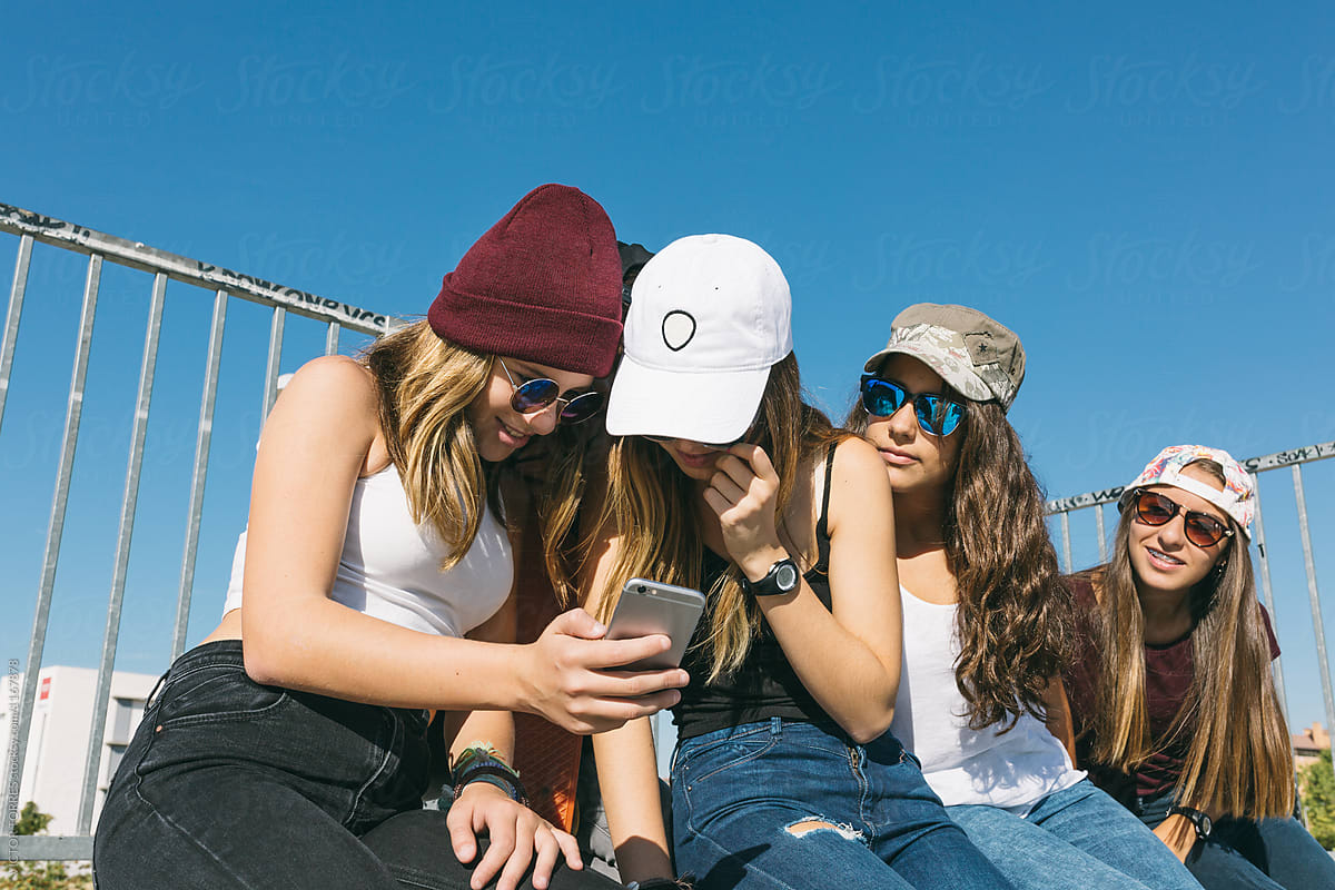 "Girls Looking At Iphone's Screen." by Stocksy Contributor "VICTOR ...