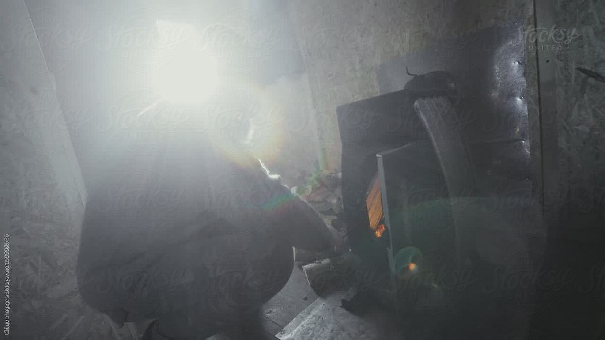 "Old Man Heating Up Stove" by Stocksy Contributor "Clique Images" - Stocksy