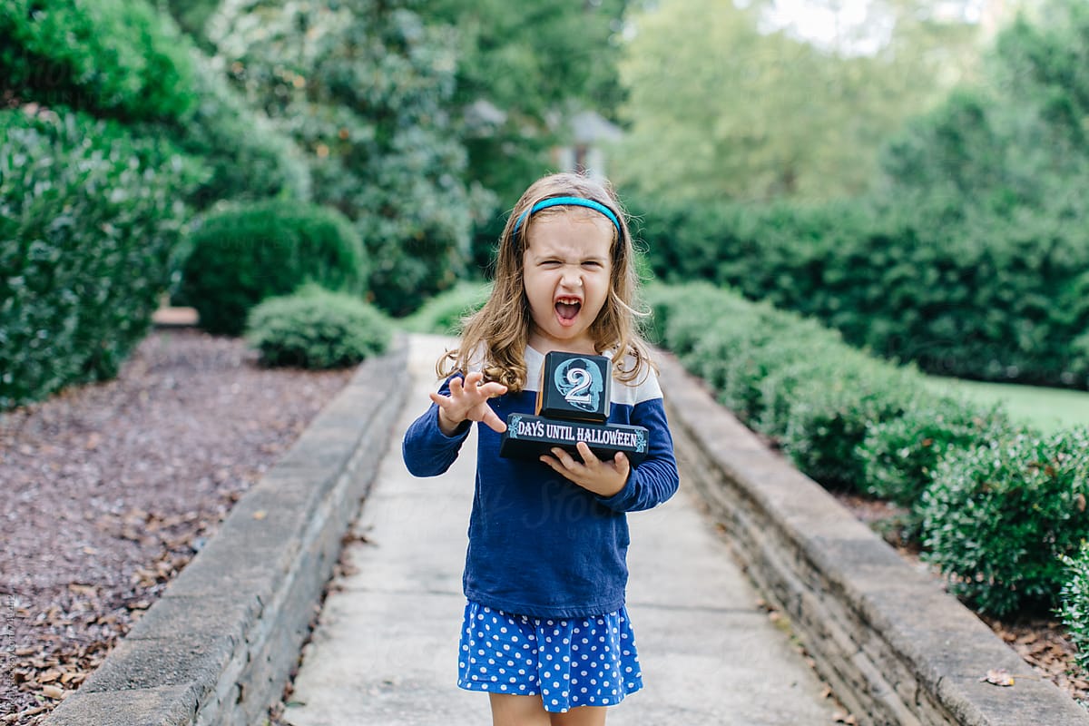 "Beautiful Young Girl Holding A Countdown Sign To Halloween" by Stocksy ...