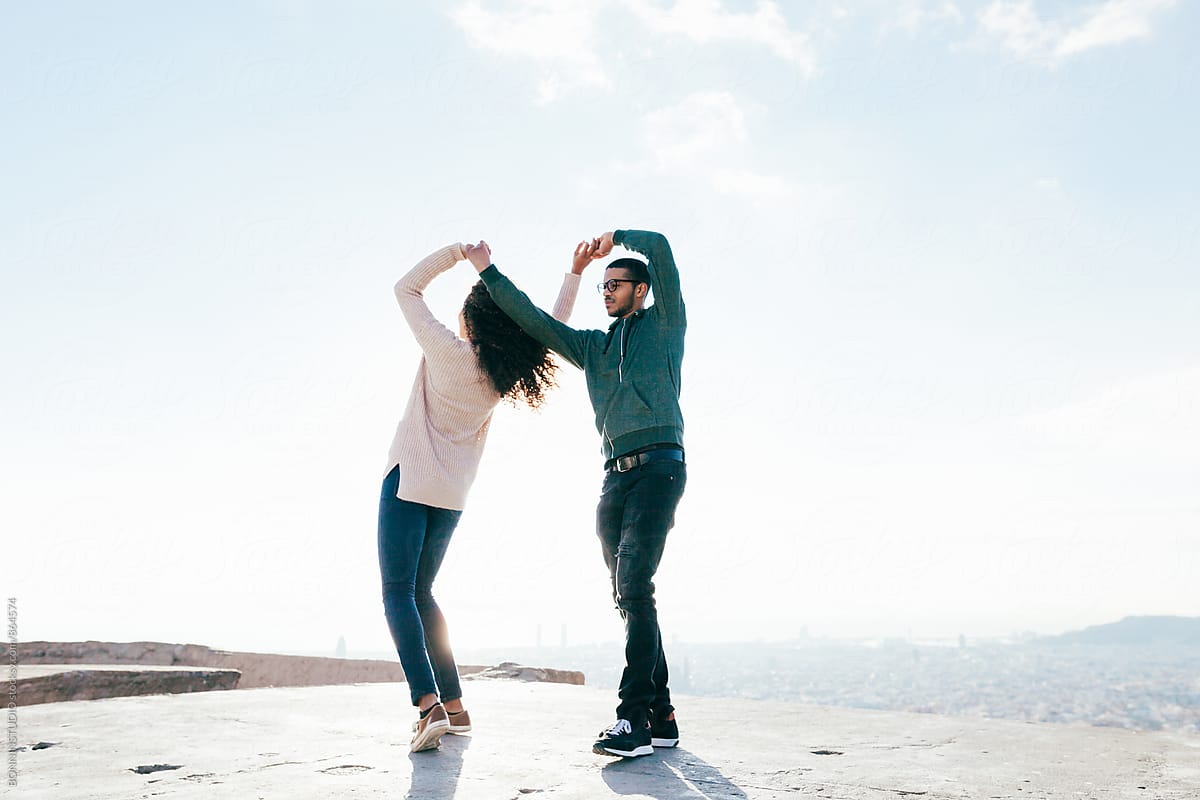 "Mixed Race Couple Dancing Above City On A Sunny Day." by Stocksy ...