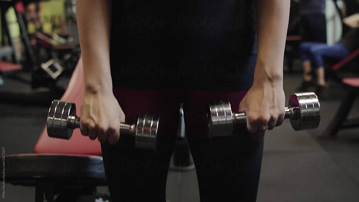 "Sweaty Woman Lifting Dumbbells And Breathing Heavily" by Stocksy ...