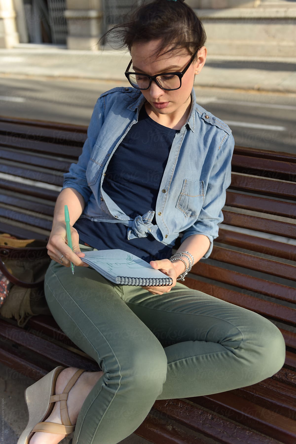"Woman Sketching On Bench" by Stocksy Contributor "Milles Studio" - Stocksy