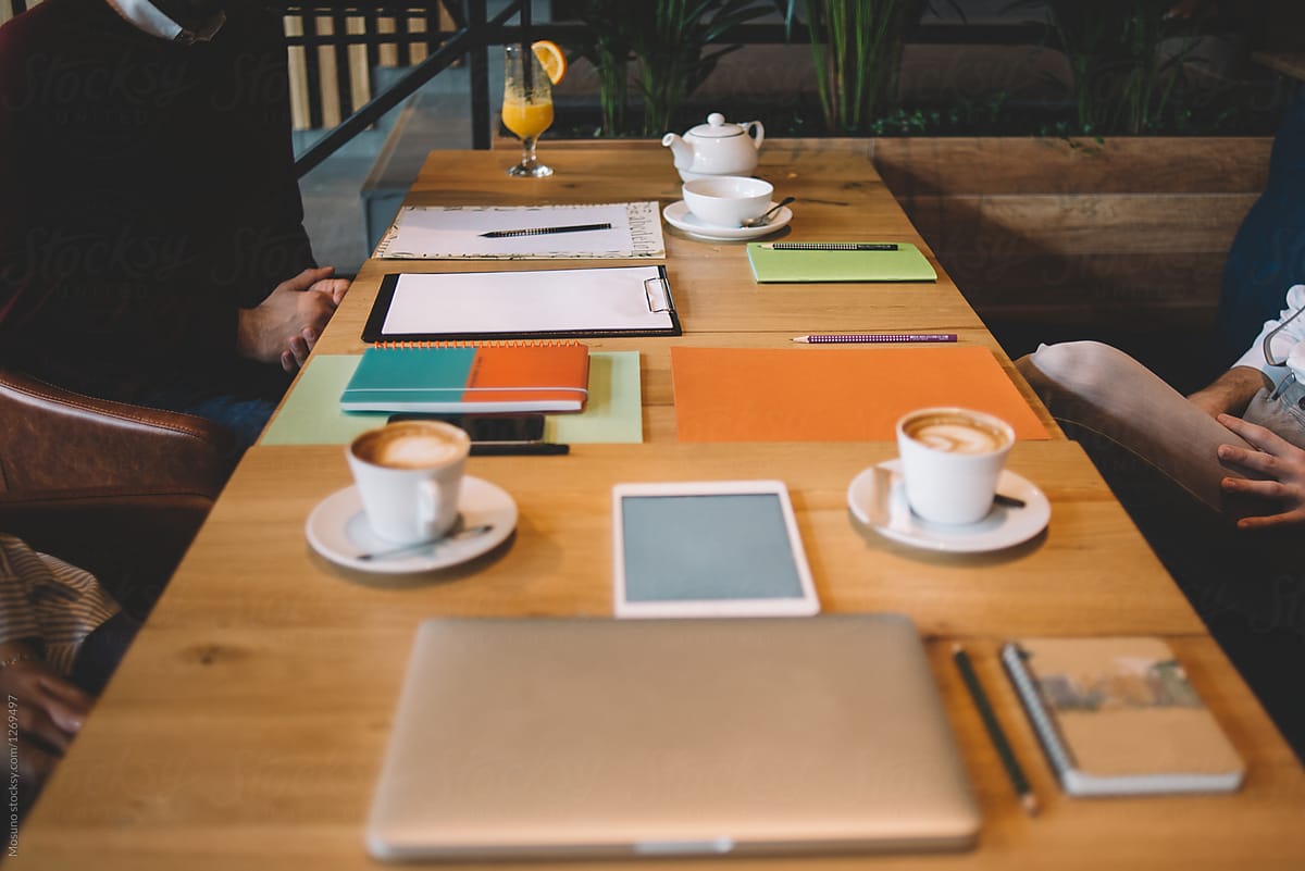 "Workstation In A Cafe" by Stocksy Contributor "Mosuno" - Stocksy