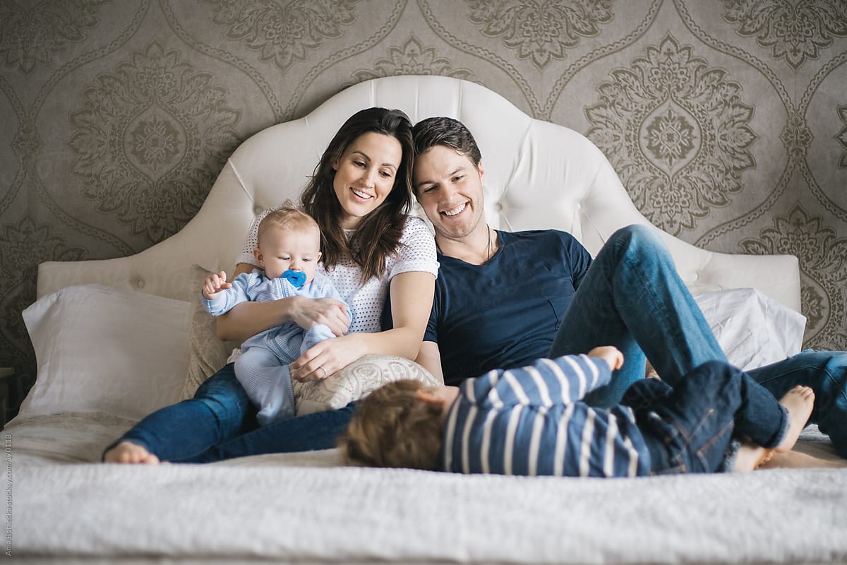 "Family Portrait Sitting In Bed, Parents And Two Sons" by Stocksy ...