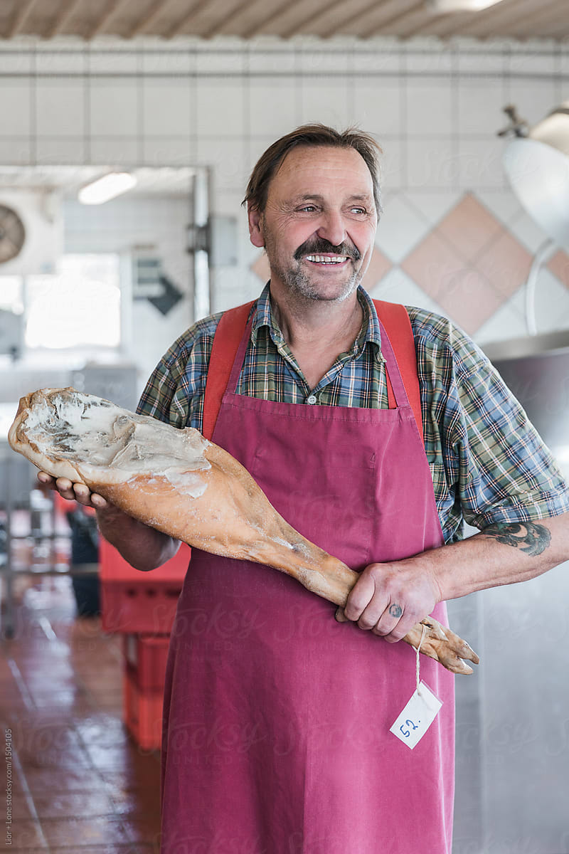 "Senior Butcher Man Smiling Holding A Cured Pig Leg" by Stocksy ...