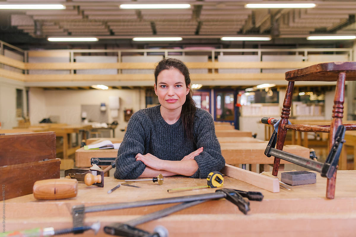 "Female Woodworker Working On A Bench, Looking At The Camera" by ...
