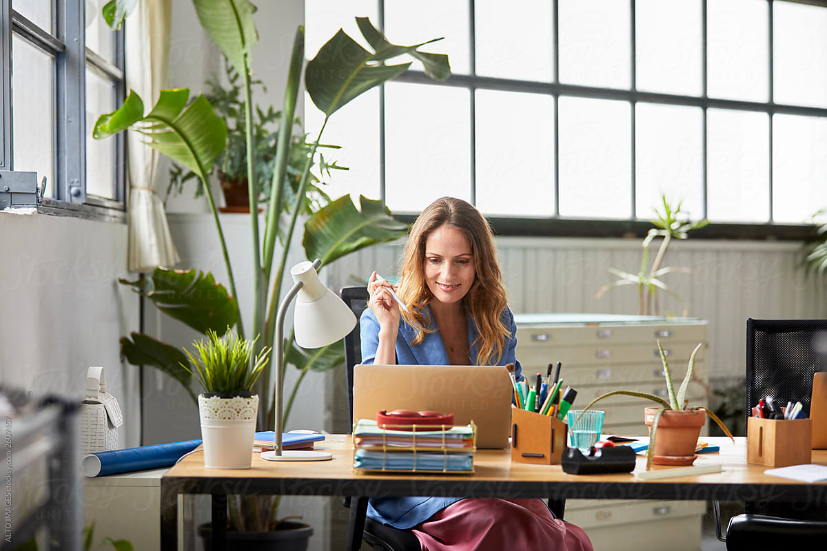 "Female Architect Reading Mail On Her Laptop" by Stocksy Contributor ...