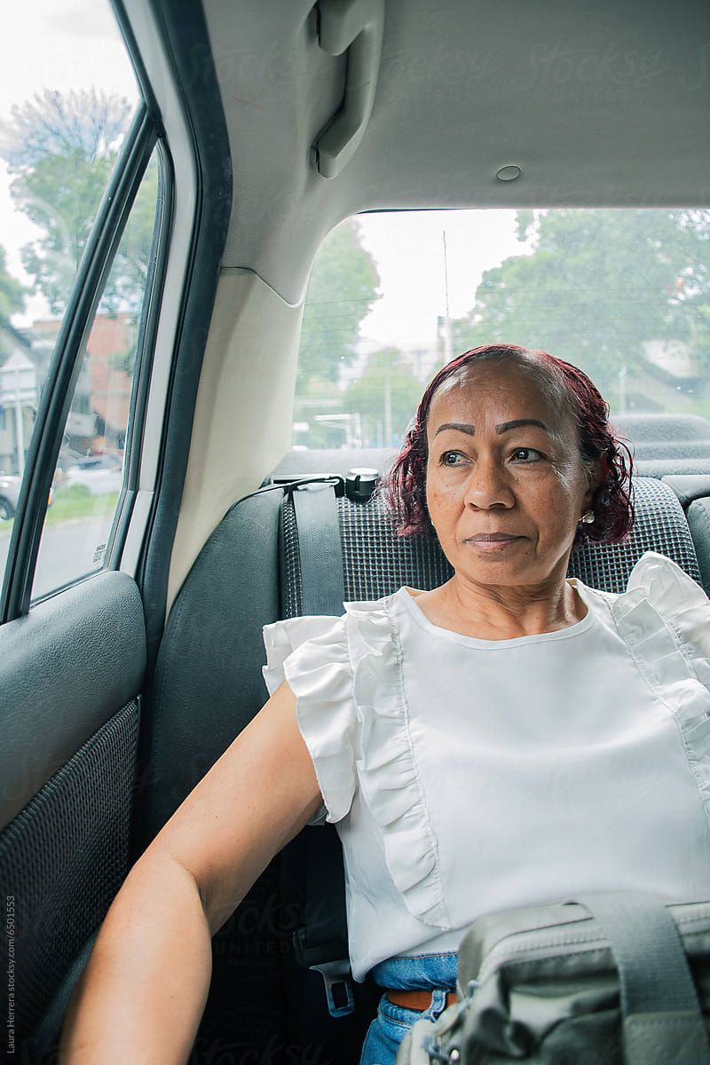 "Smiling Senior Woman Traveling In The Back Seat Of A Car" by Stocksy ...