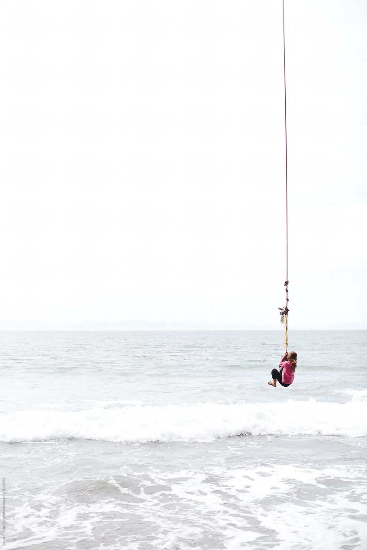 "Young Girl Flying Over Ocean Water On Rope Swing" by Stocksy ...