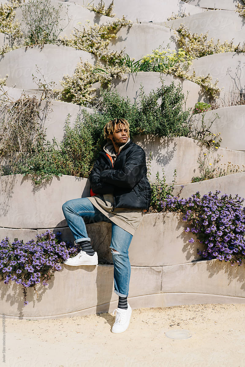 "Relaxed Black Man Sitting On Wall With Flowers" by Stocksy Contributor ...