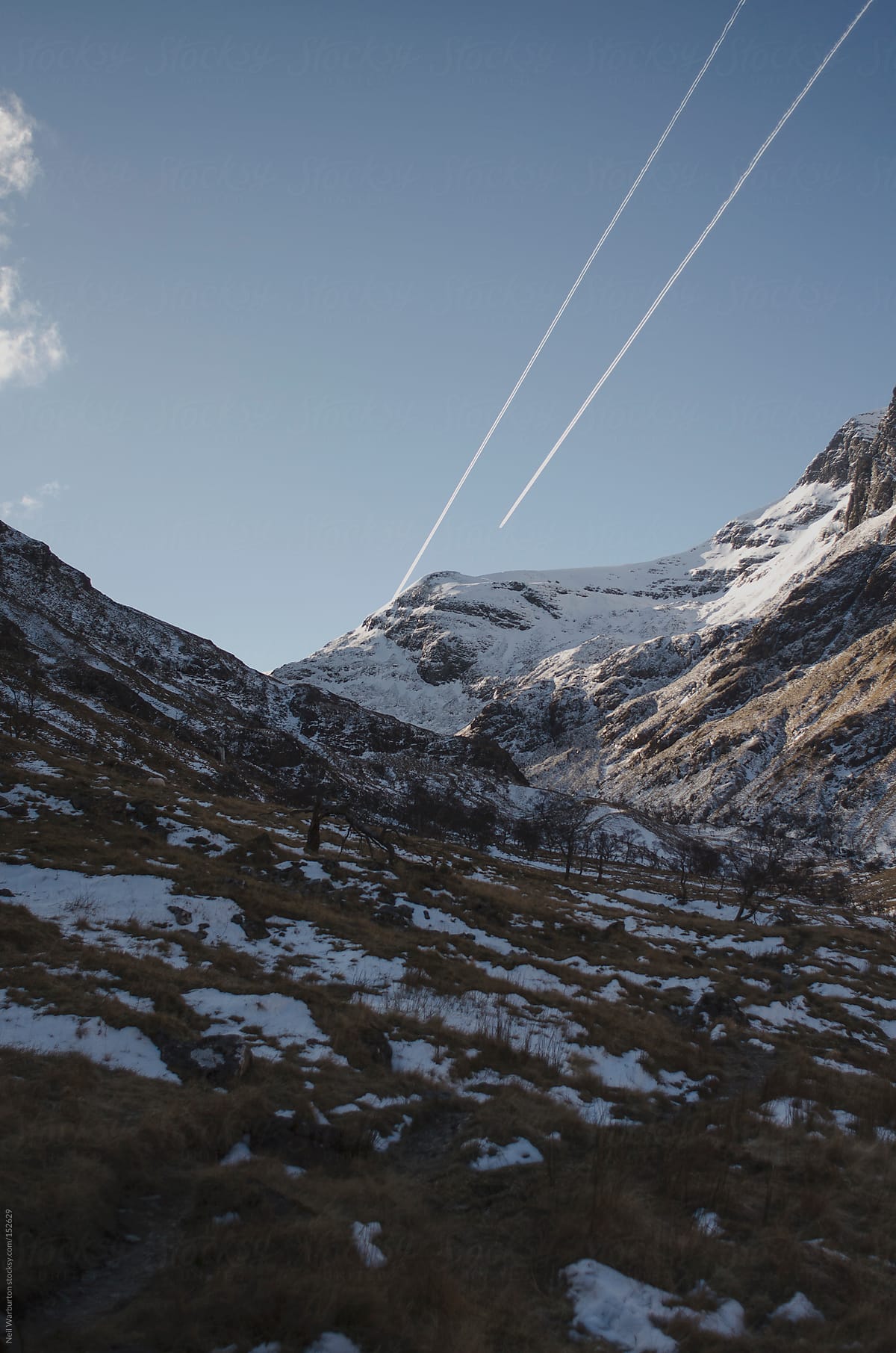 "Plane Trails Over Mountain Peak" by Stocksy Contributor "Neil ...