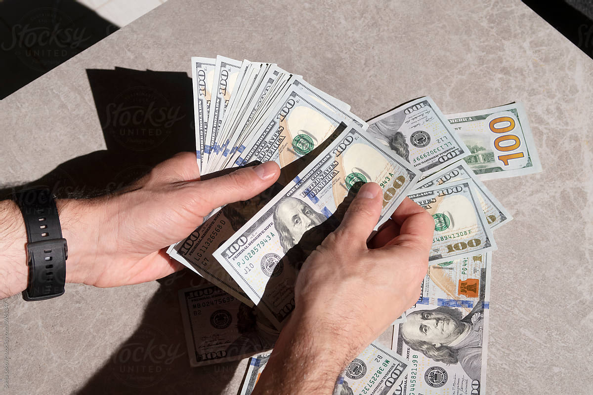 "Counting A Pile Of Hundred Dollar Bills Closeup" by Stocksy ...