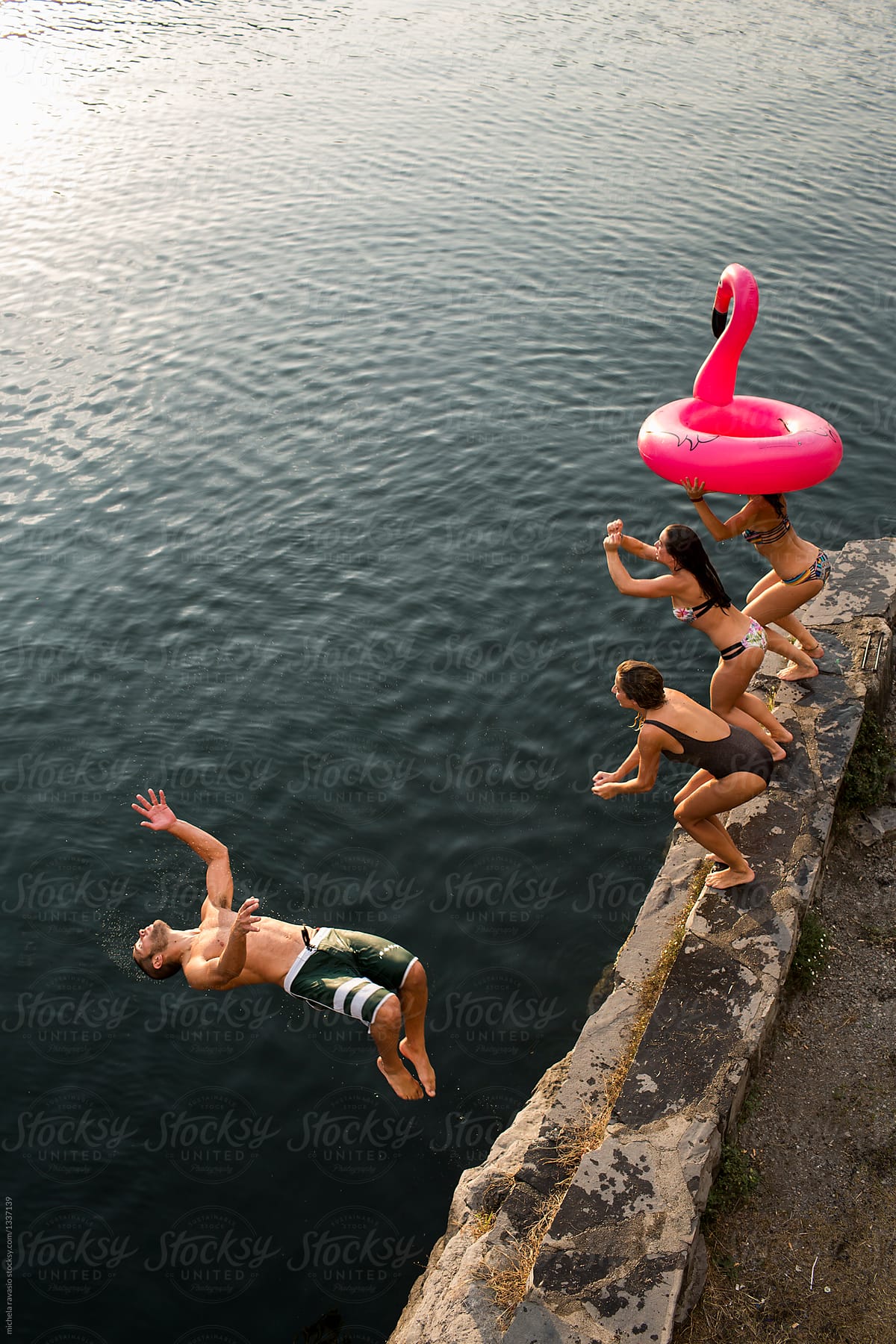 "Group Of Friends Jumping Into The Water From A Wall" by Stocksy ...