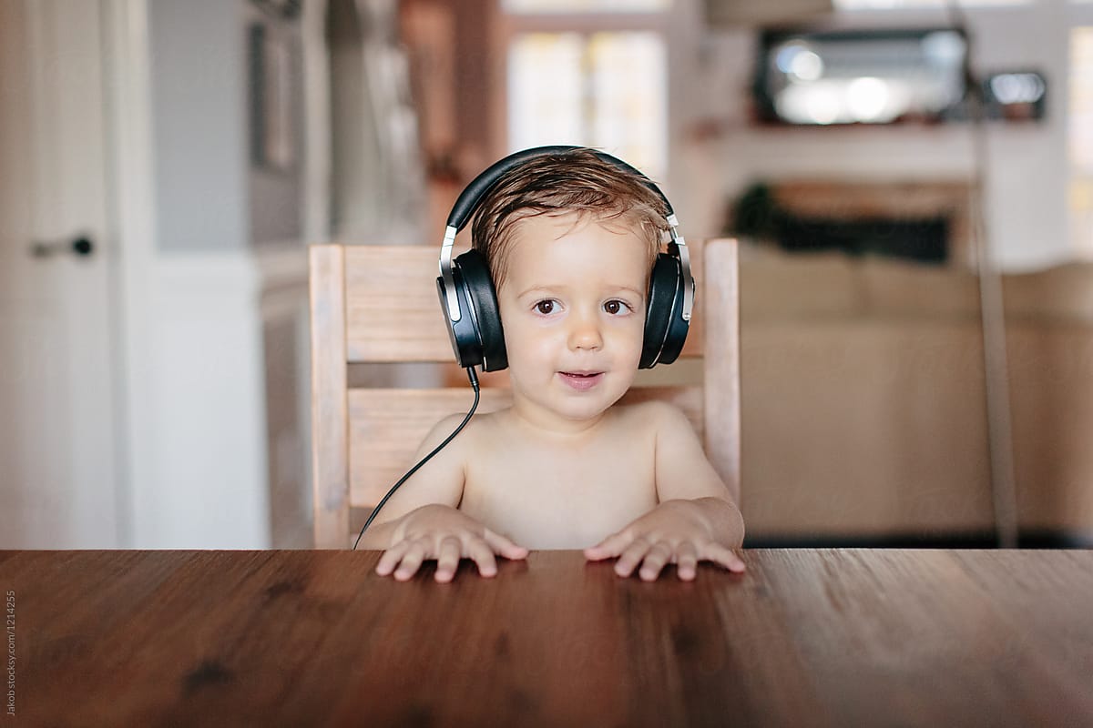 "Cute Young Boy Listening To Music Intently With Big Headphones" by ...