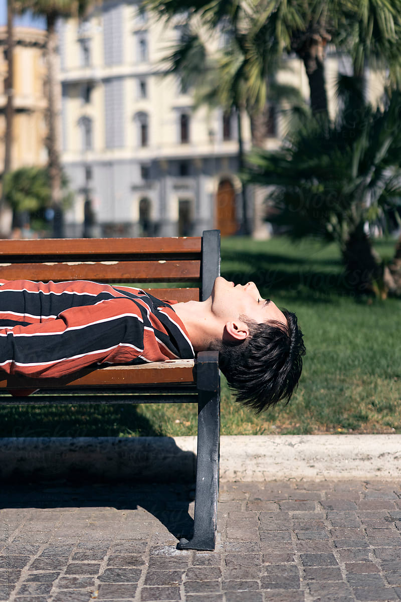 "Young Man Laying Down On A Bench In The Park Relaxing" by Stocksy ...