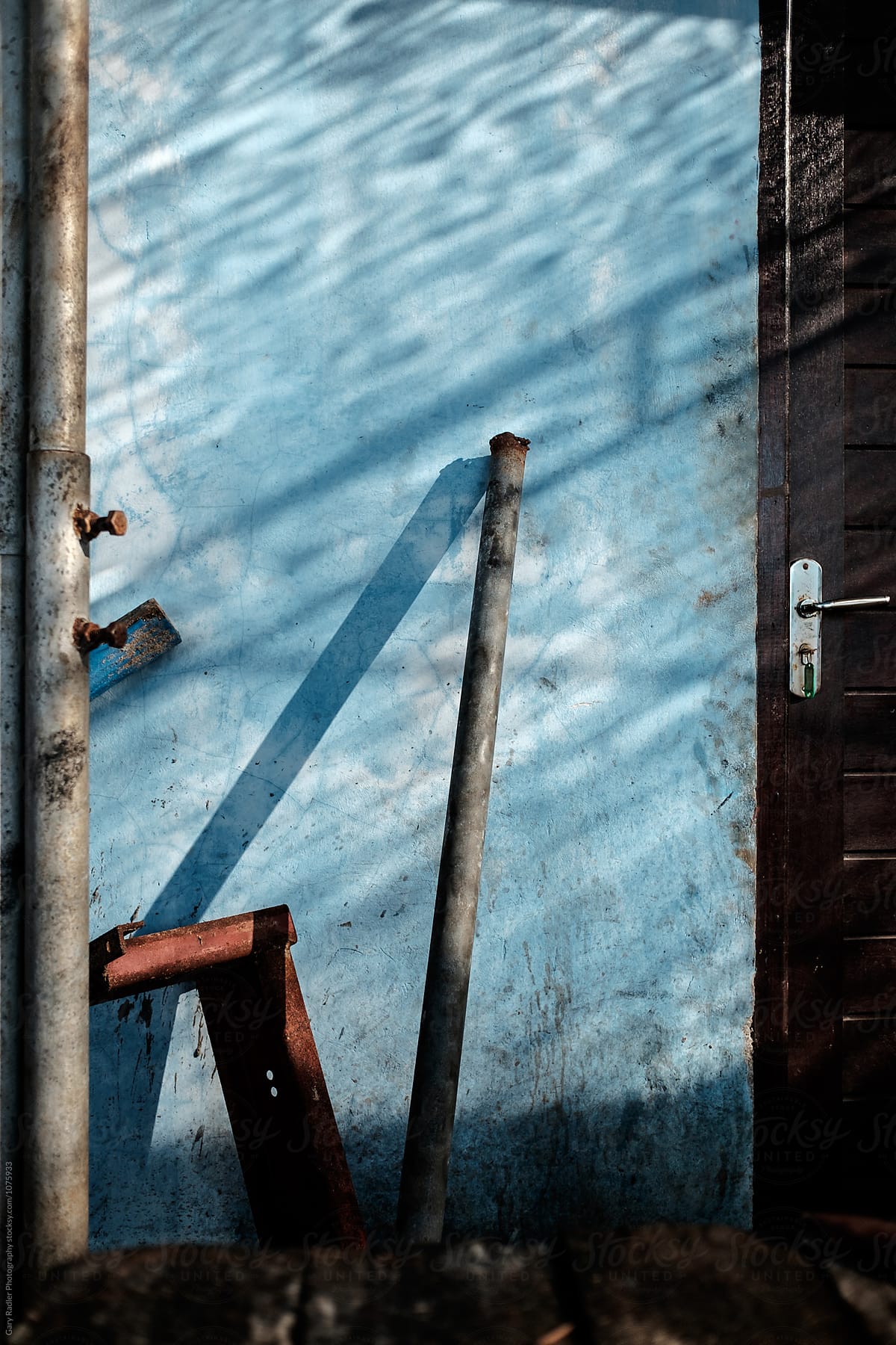 "Objects Leaning On A Blue Wall" by Stocksy Contributor "Gary Radler ...