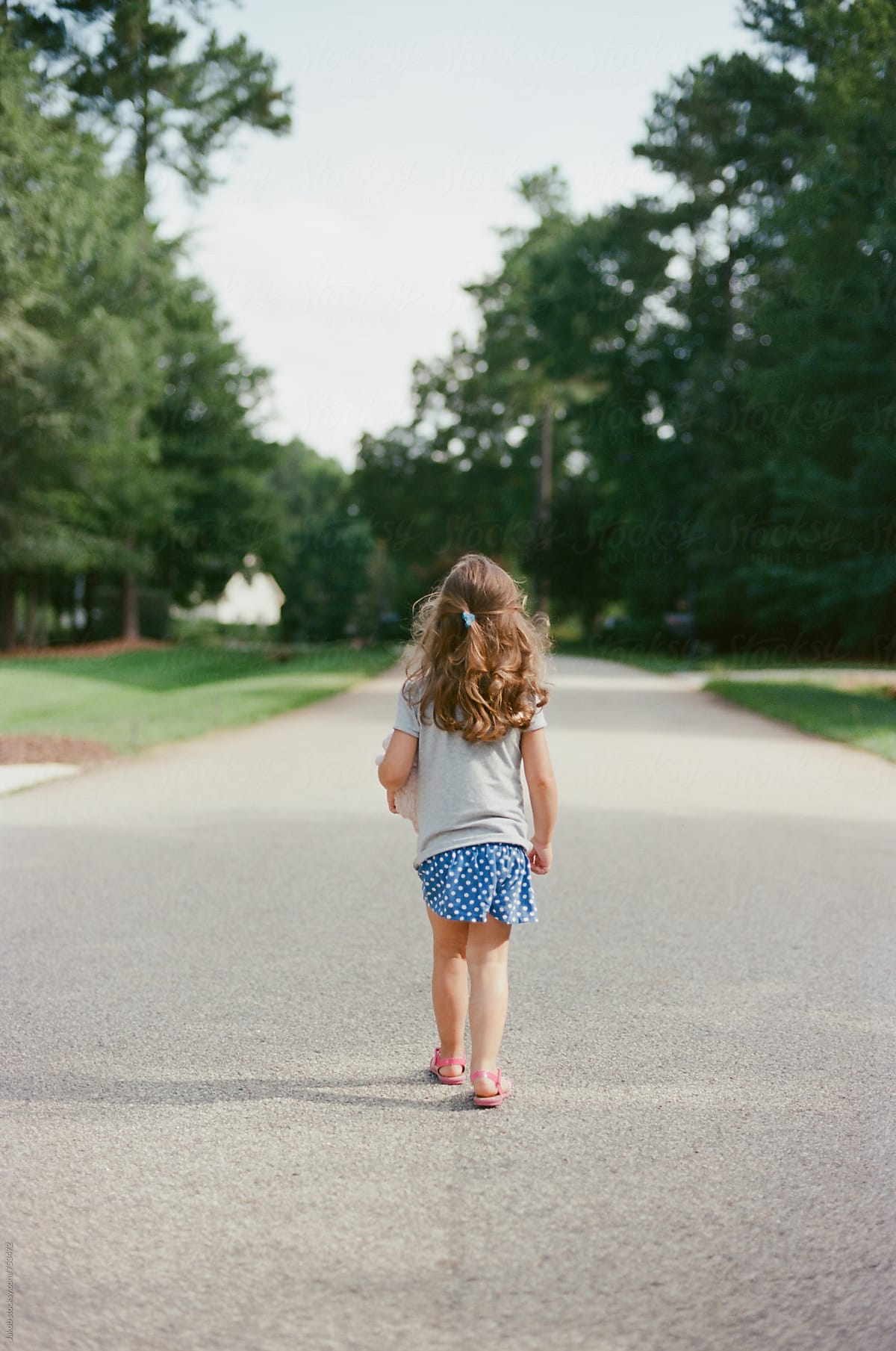 Little Girl Walking Down The Street Child Walking On Street Alone