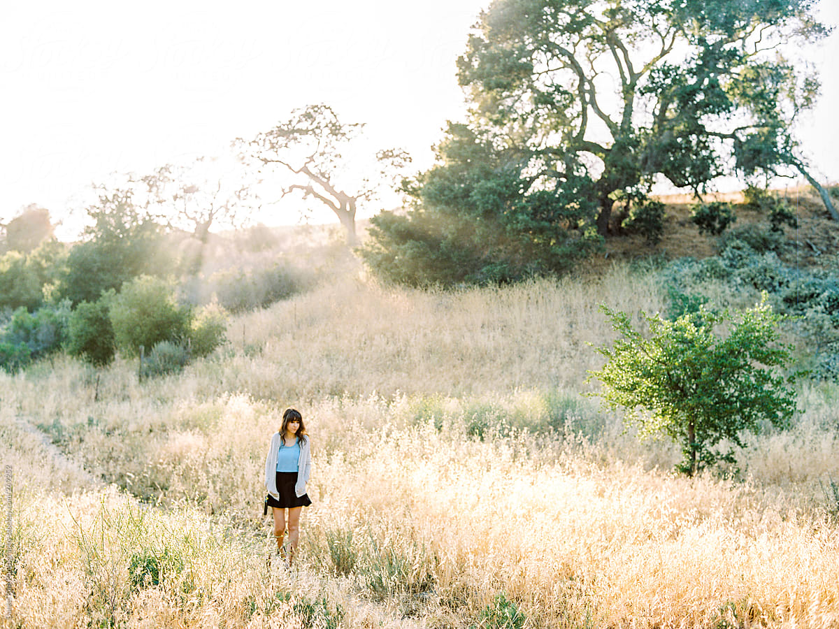 "Girl Walking Down Sunlit Path" by Stocksy Contributor "Daniel Kim ...