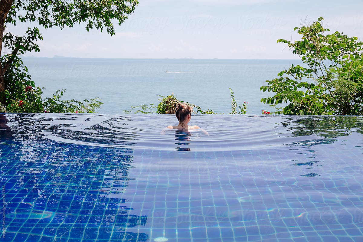"Young Woman Swimming In The Infinity Swimming Pool" by Stocksy ...
