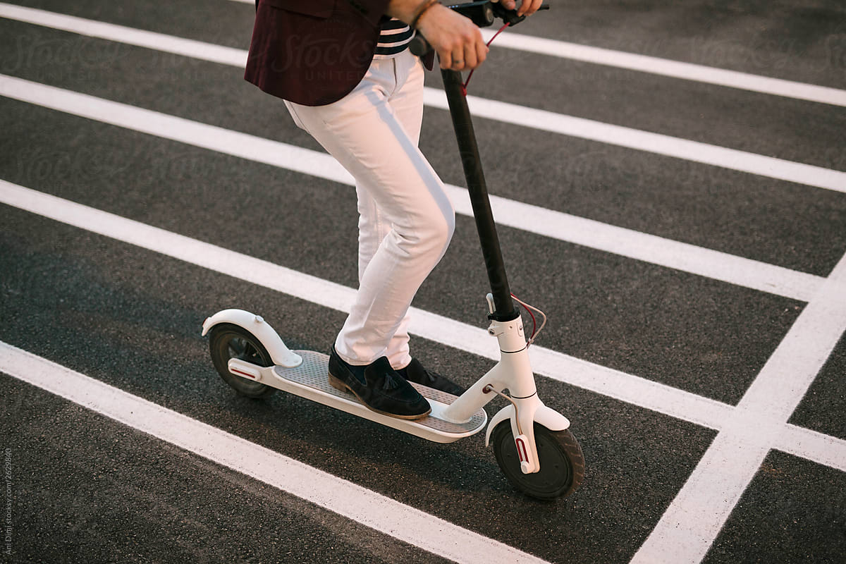 "Man With Scooter" by Stocksy Contributor "Ani Dimi" - Stocksy