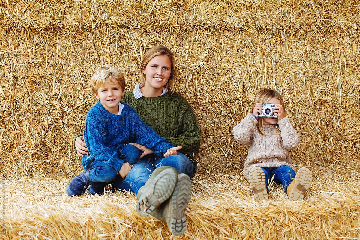 "Mother And Kids Having Fun Sitting On A Haystack." by Stocksy ...