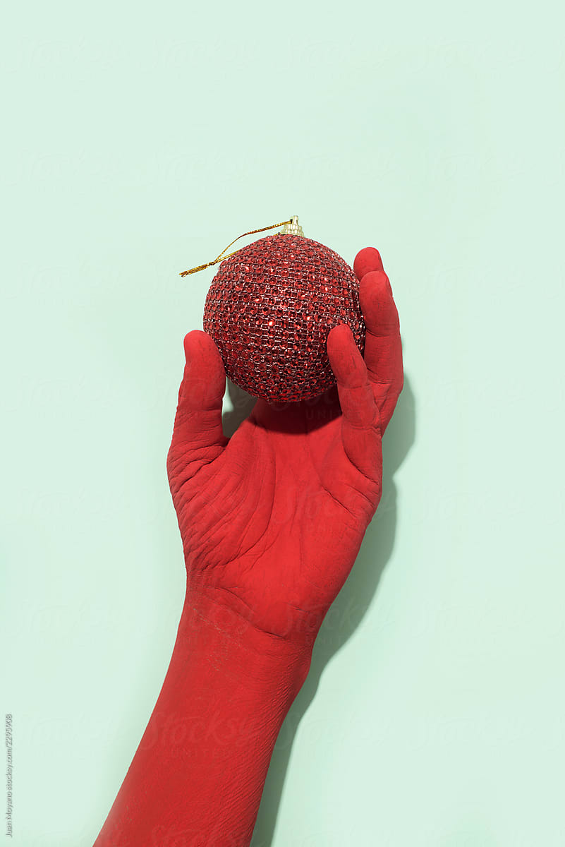 "Red Hand With A Red Christmas Ball" by Stocksy Contributor "Juan ...