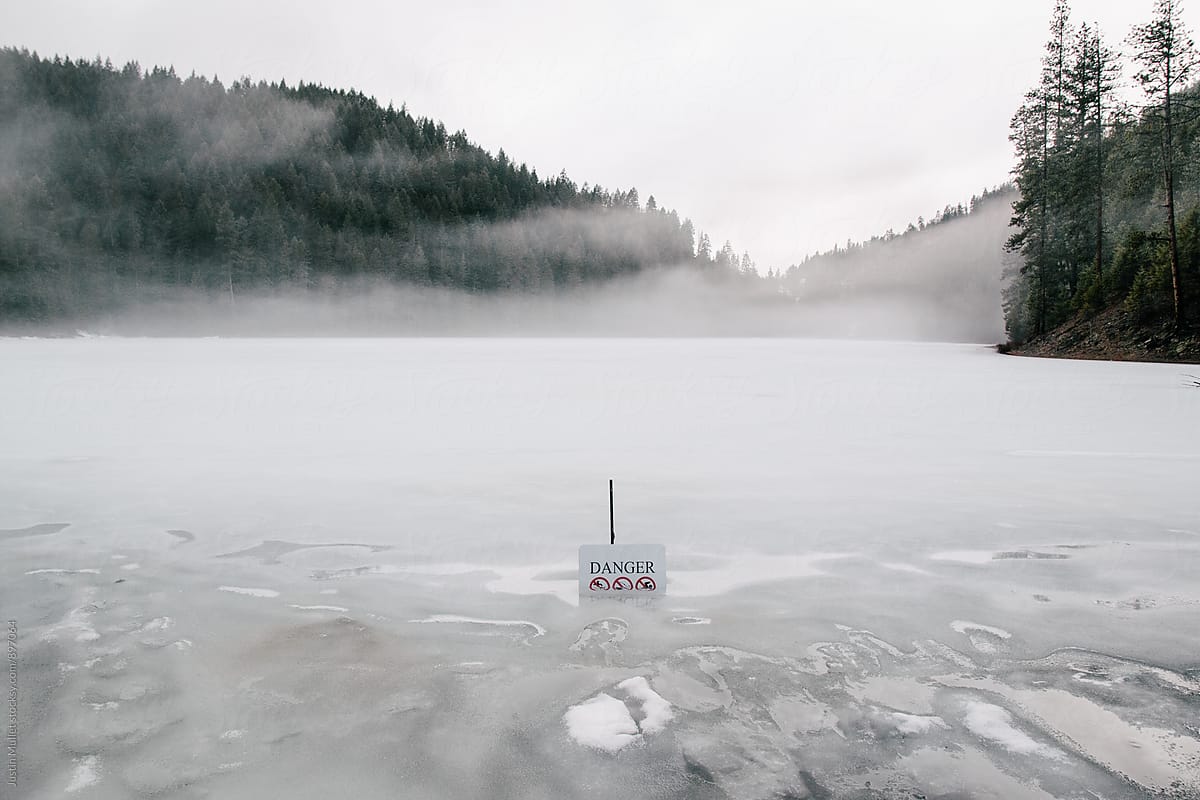 "Danger Sign On A Frozen Lake" by Stocksy Contributor "Justin Mullet ...