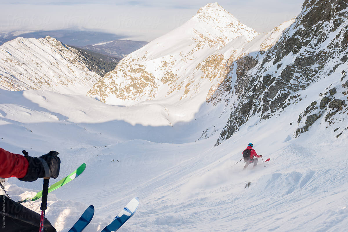 "Skiers Free Riding On Steep Slope On A Bright Day" by Stocksy ...