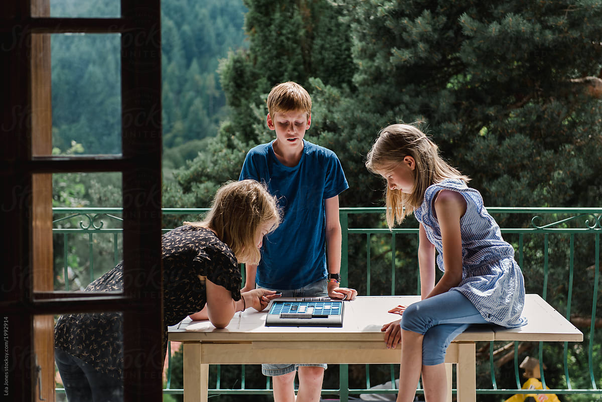 "Tweens Playing A Board Game" by Stocksy Contributor "Lea Jones" - Stocksy