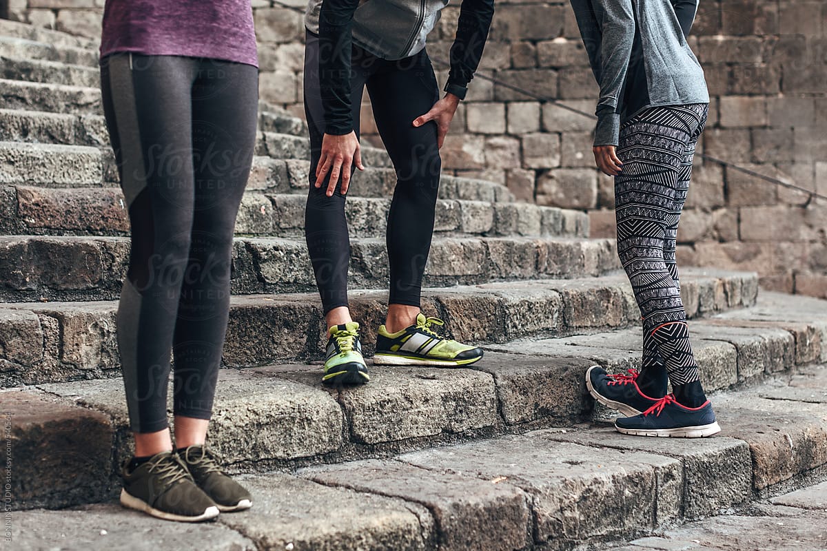"Group Of Runners Doing Stretching Exercises On Steps." by Stocksy ...