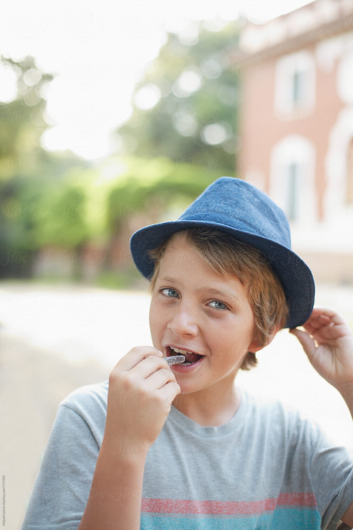 "Portrait Of A Young Man Eating A Candy" by Stocksy Contributor "Miquel ...