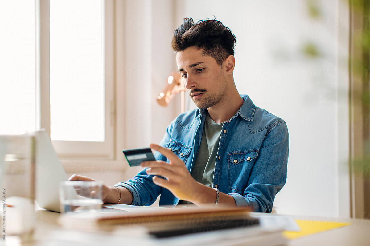 "Young Man Transferring Money Online" by Stocksy Contributor "sofie ...