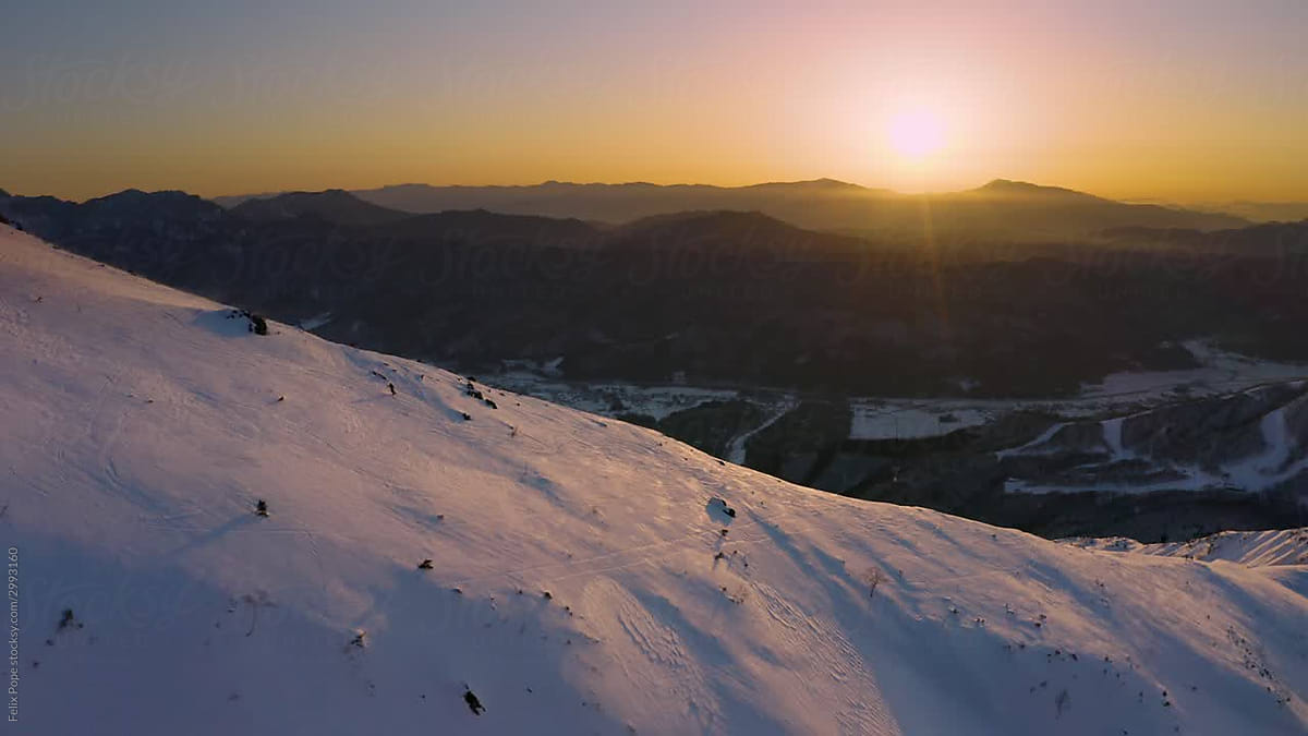 "Sunrise Snowboarding" by Stocksy Contributor "Felix Pope" - Stocksy